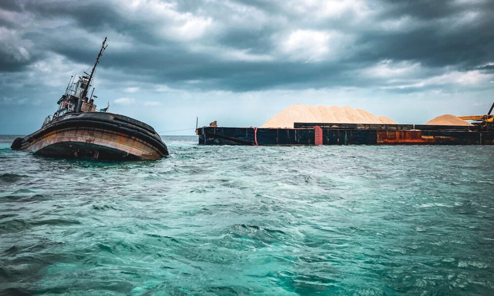 A year later, stranded tug and barge still scars reef in Fowl Cays ...